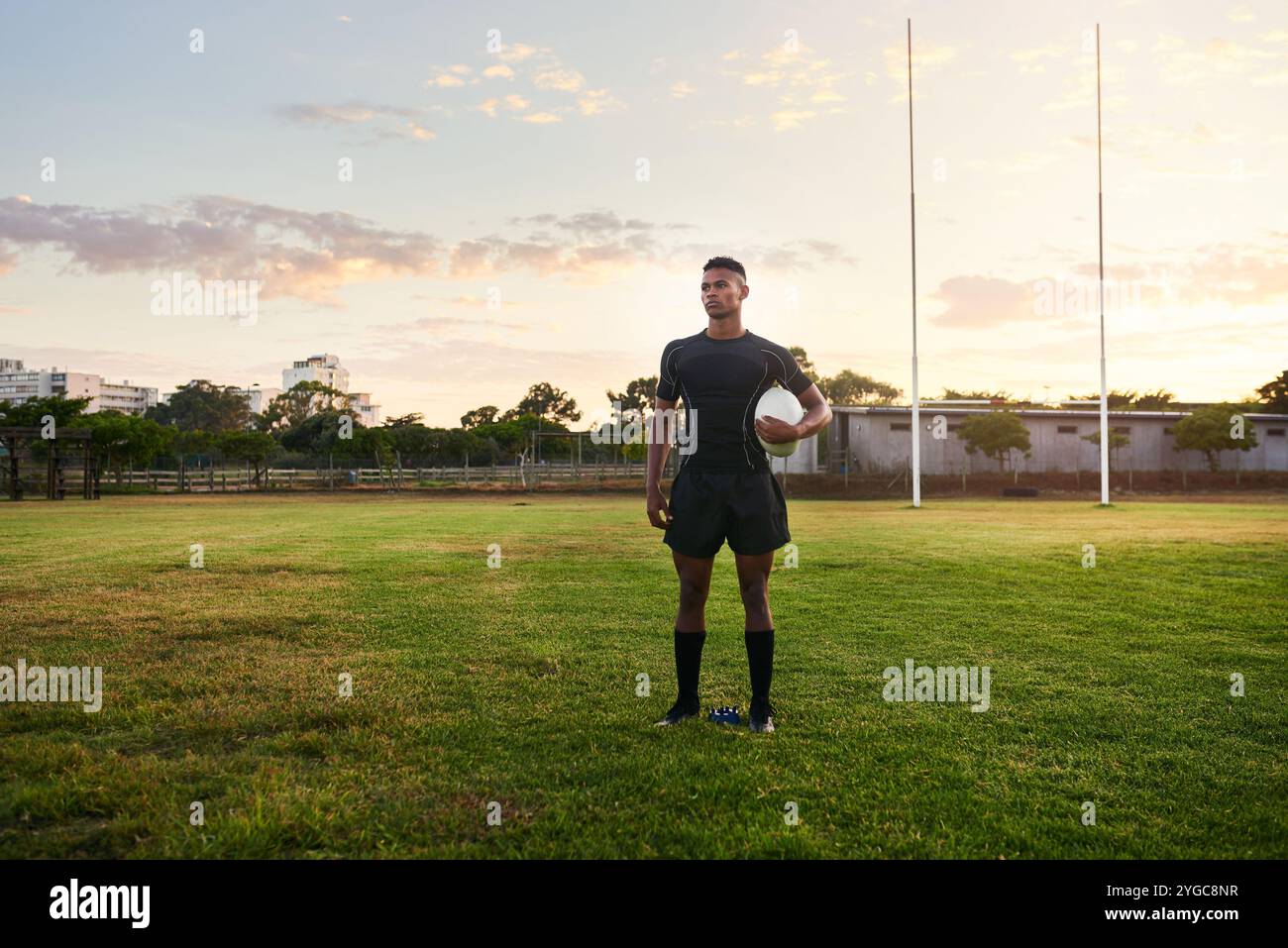Rugby, man and thinking on field with ball, training ambition and ...