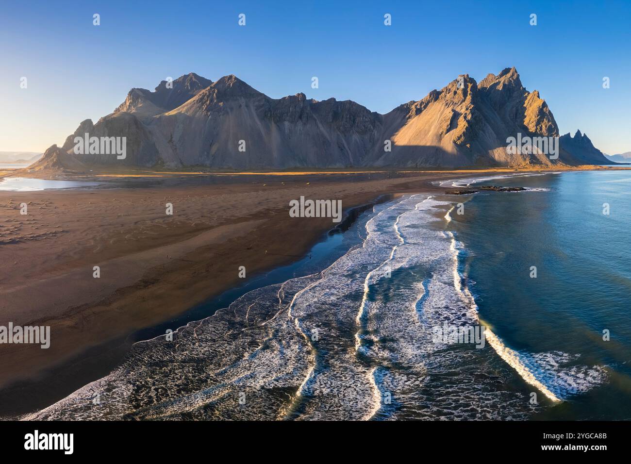 Aerial view of the black sand dunes in front of Vestrahorn mountain ...