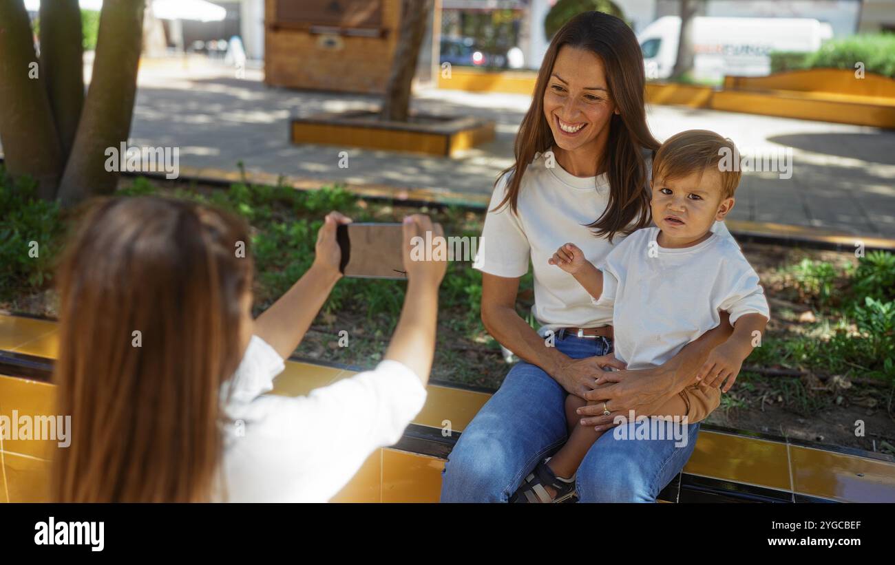 Woman with two children enjoying urban park outdoors capturing moments ...