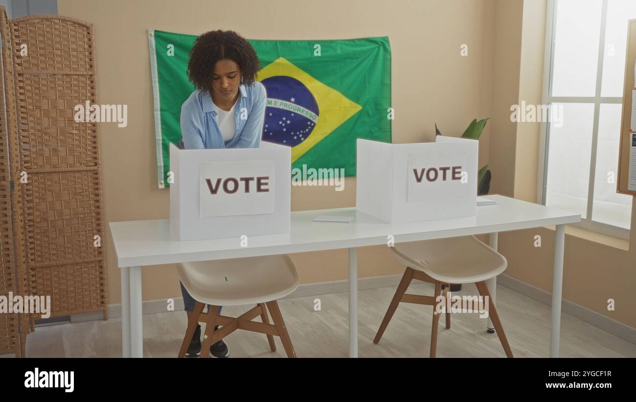 Young african american woman voting in an electoral college room with a ...