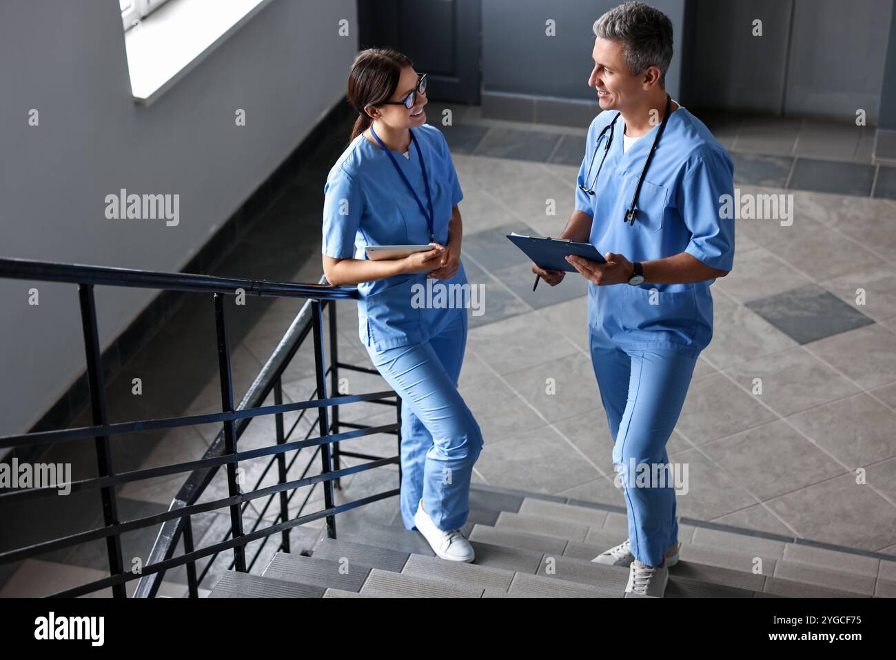 Healthcare workers talking on stairs in hospital Stock Photo - Alamy