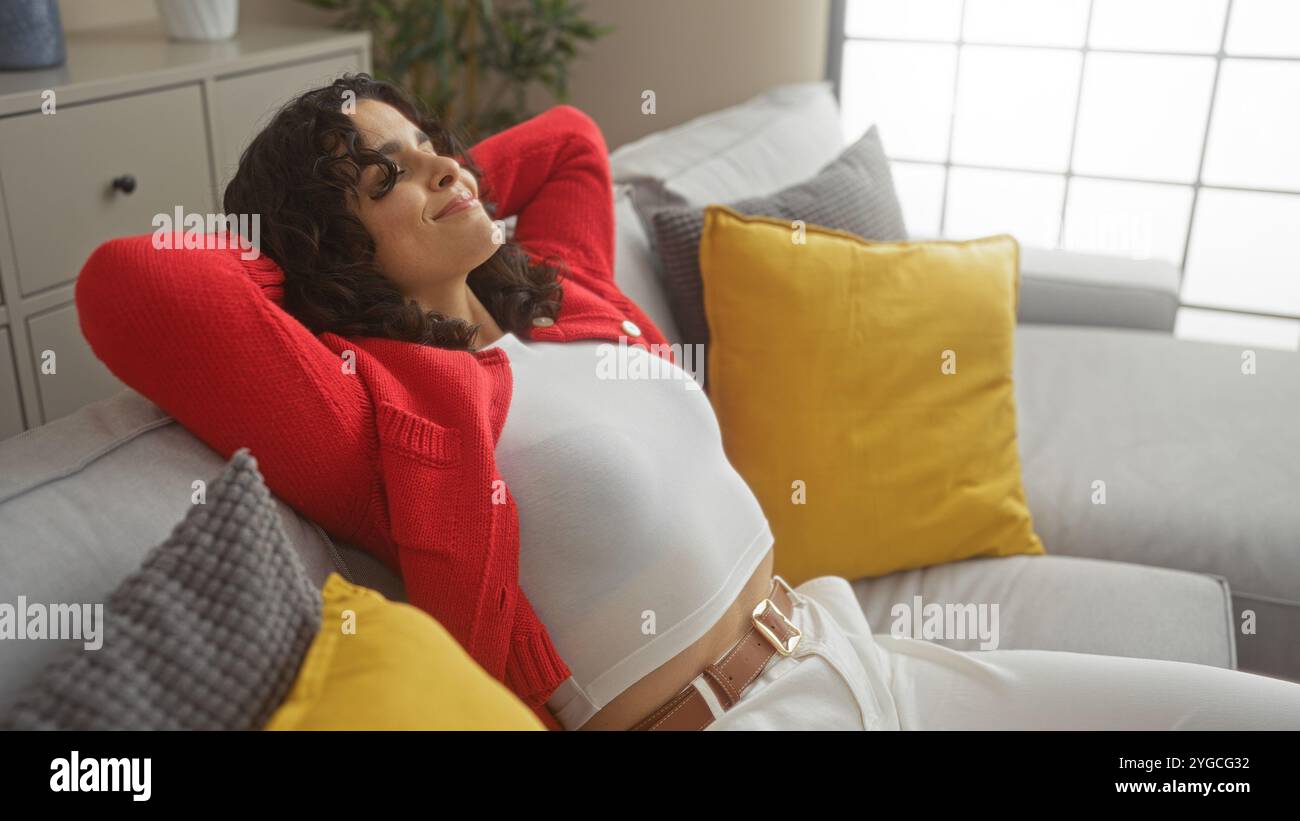 Relaxed young hispanic woman lounging in a cozy living room with bright ...