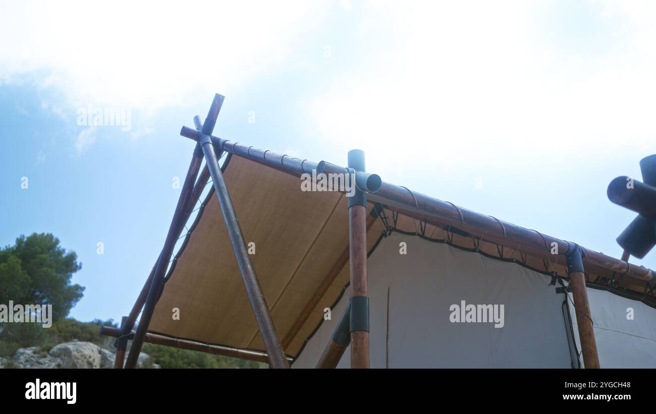 Simple bamboo tent in an african wilderness setting under a clear sky ...