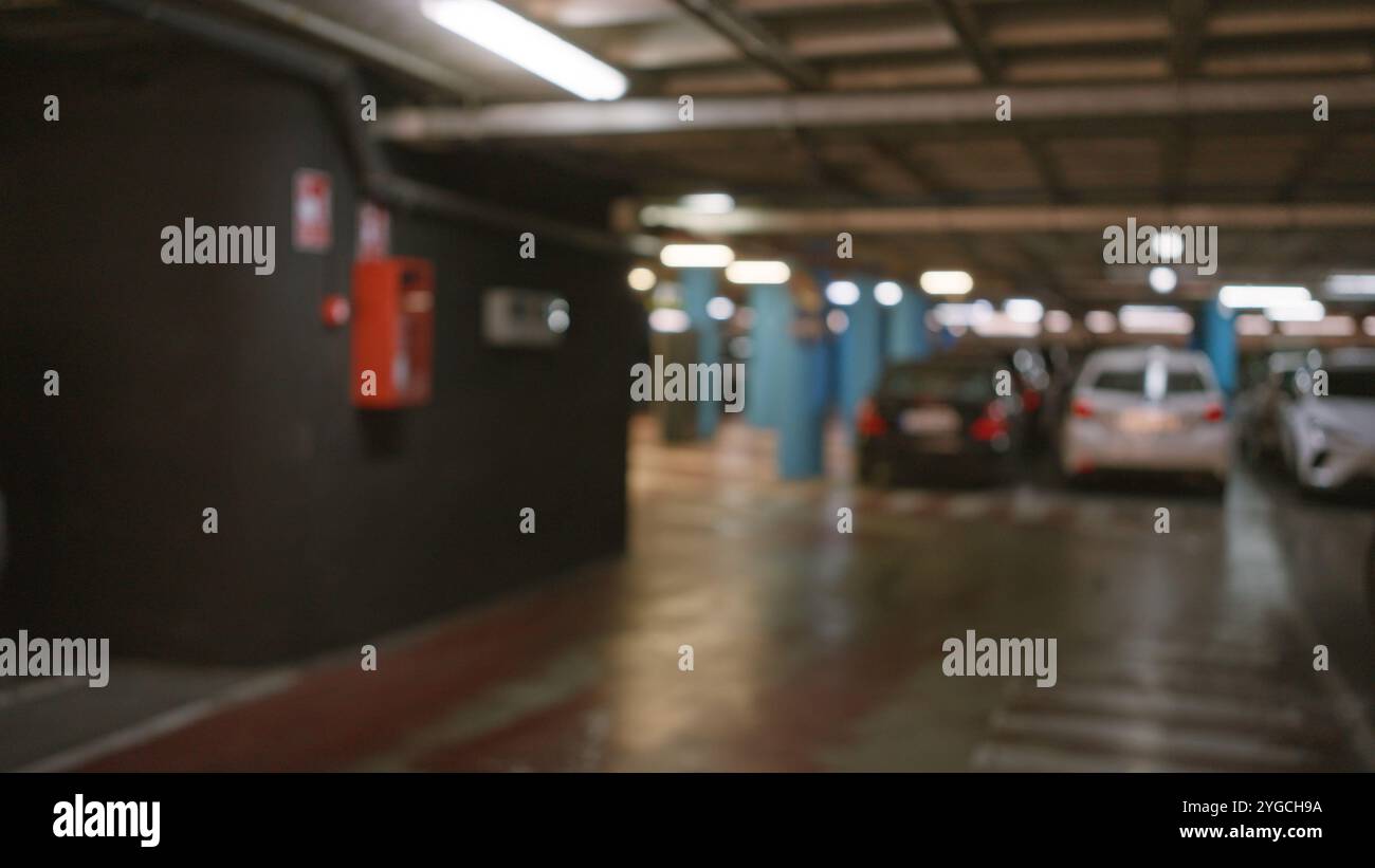 Blurred view of an out-of-focus parking garage featuring several ...