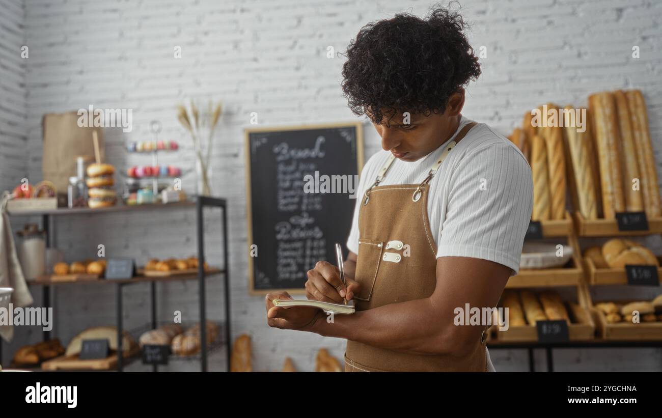 Young man in bakery checking hi-res stock photography and images - Alamy