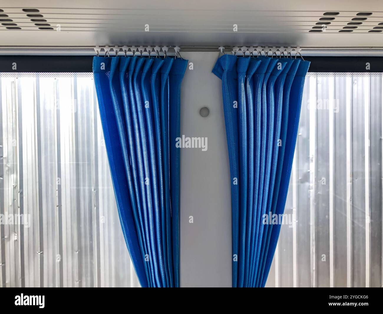 Shot of blue curtains installed on the windows of new air conditioned ...