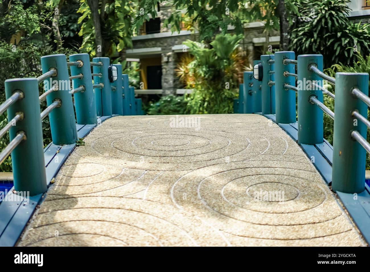 A stable bridge with circle wave pattern stone floor and metal railing ...
