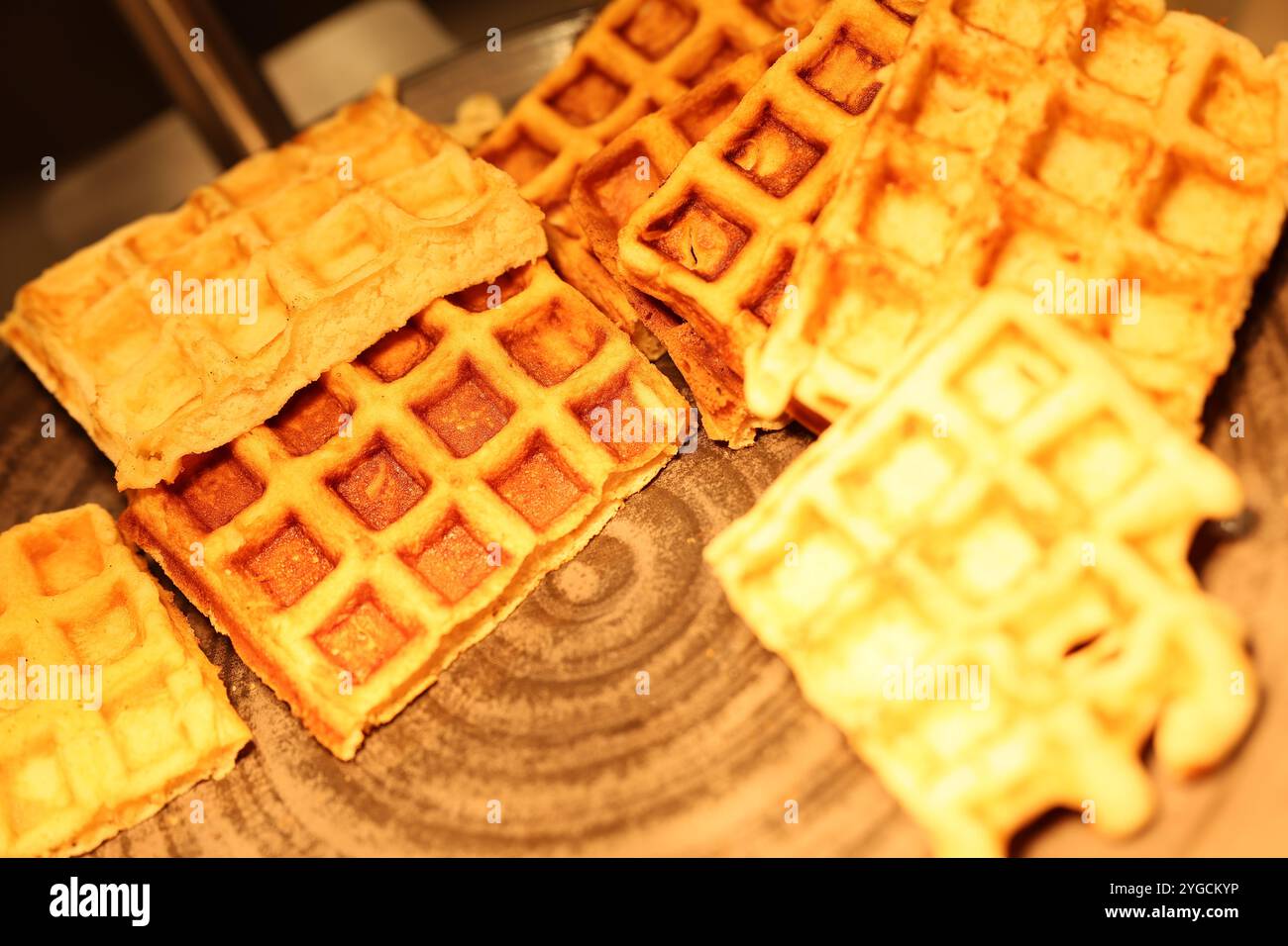 Indulge in Delicious Golden Waffles that are Perfectly Piled High for a ...