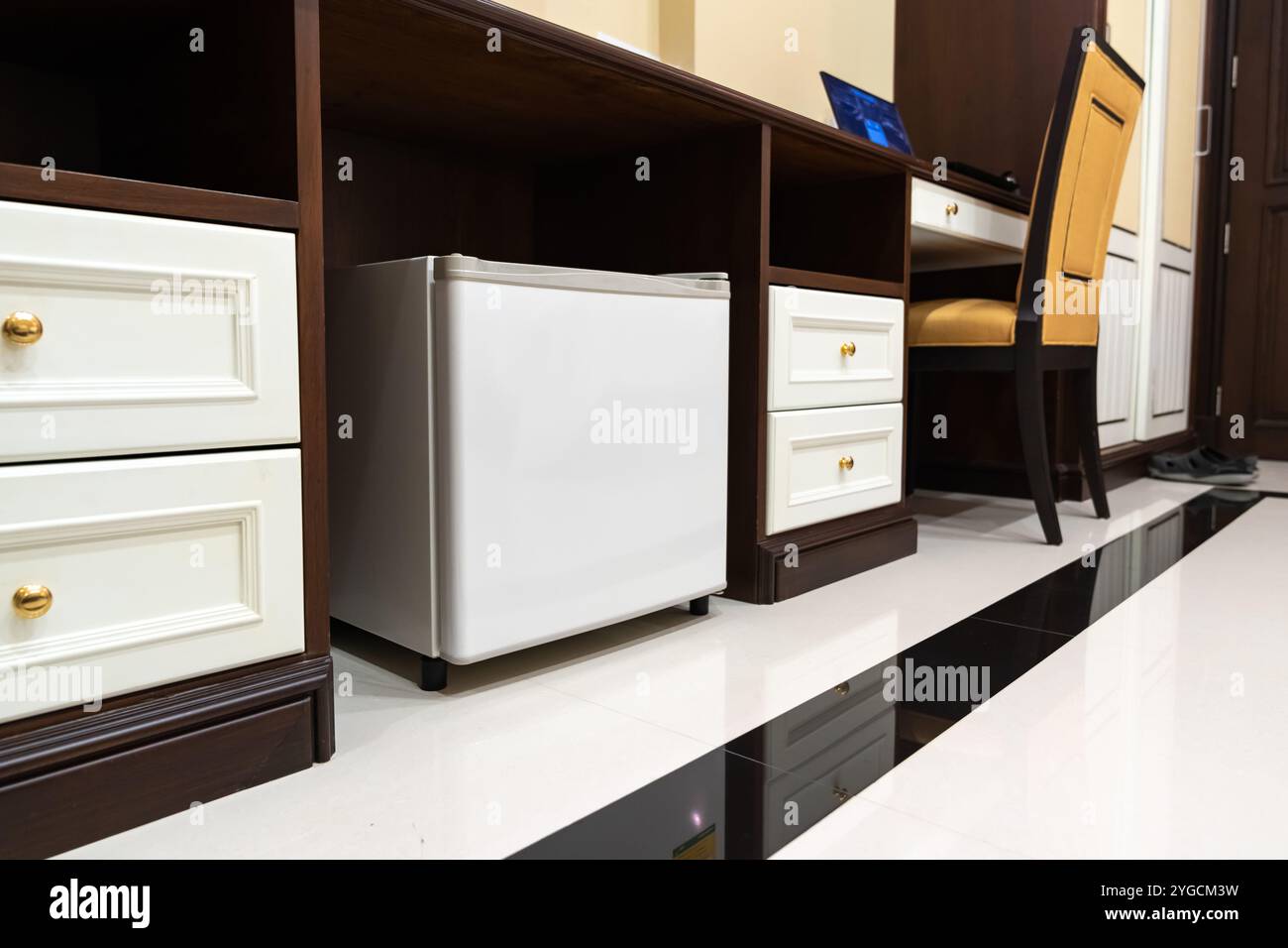 mini fridge in low angle view, inside it’s empty shelves placed under ...