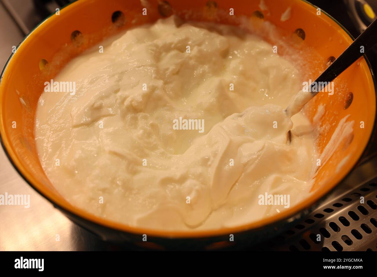 A bowl filled with a creamy white mixture, perfect for various culinary ...