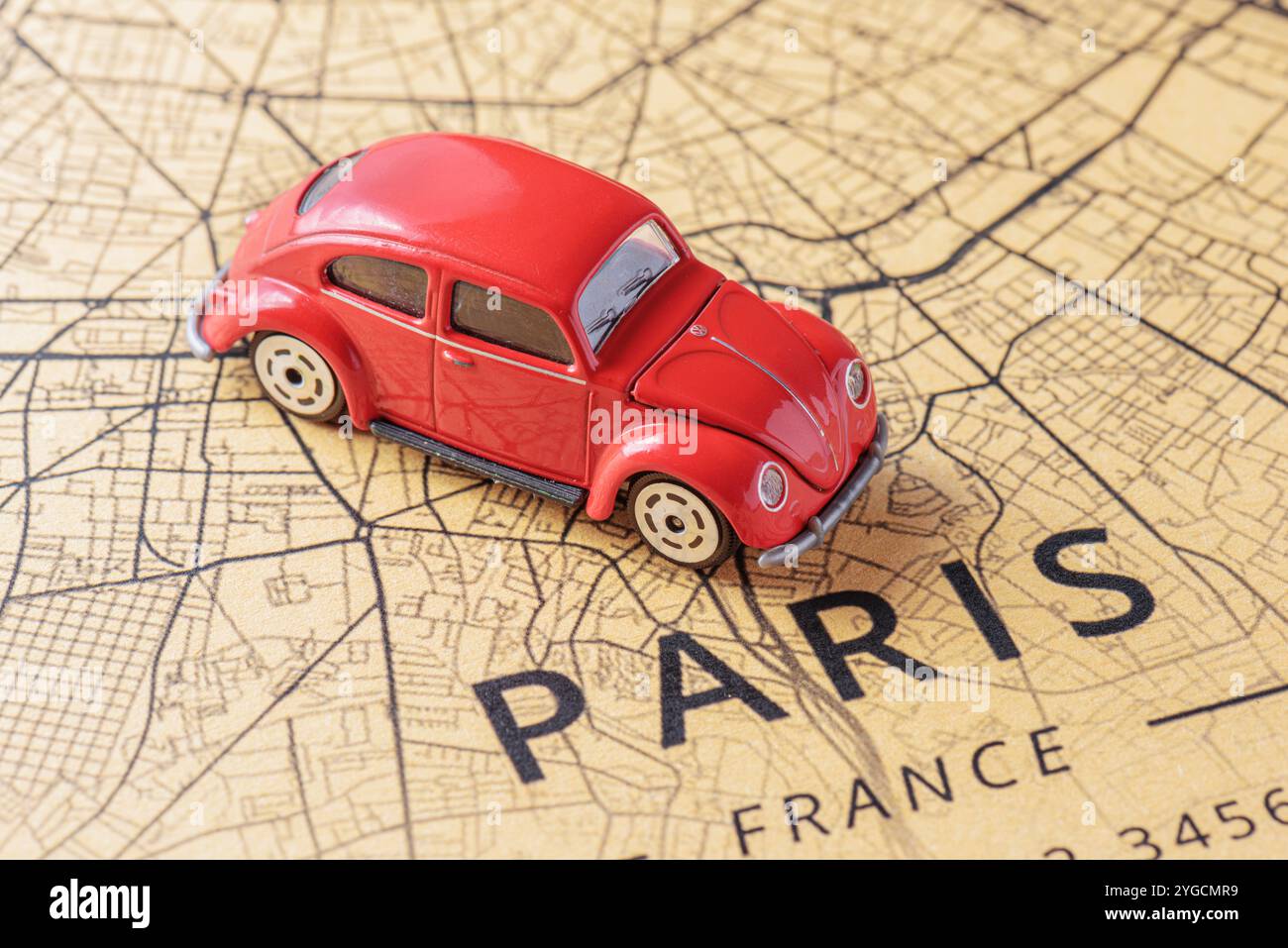 Red toy car drove into Paris, France Stock Photo - Alamy