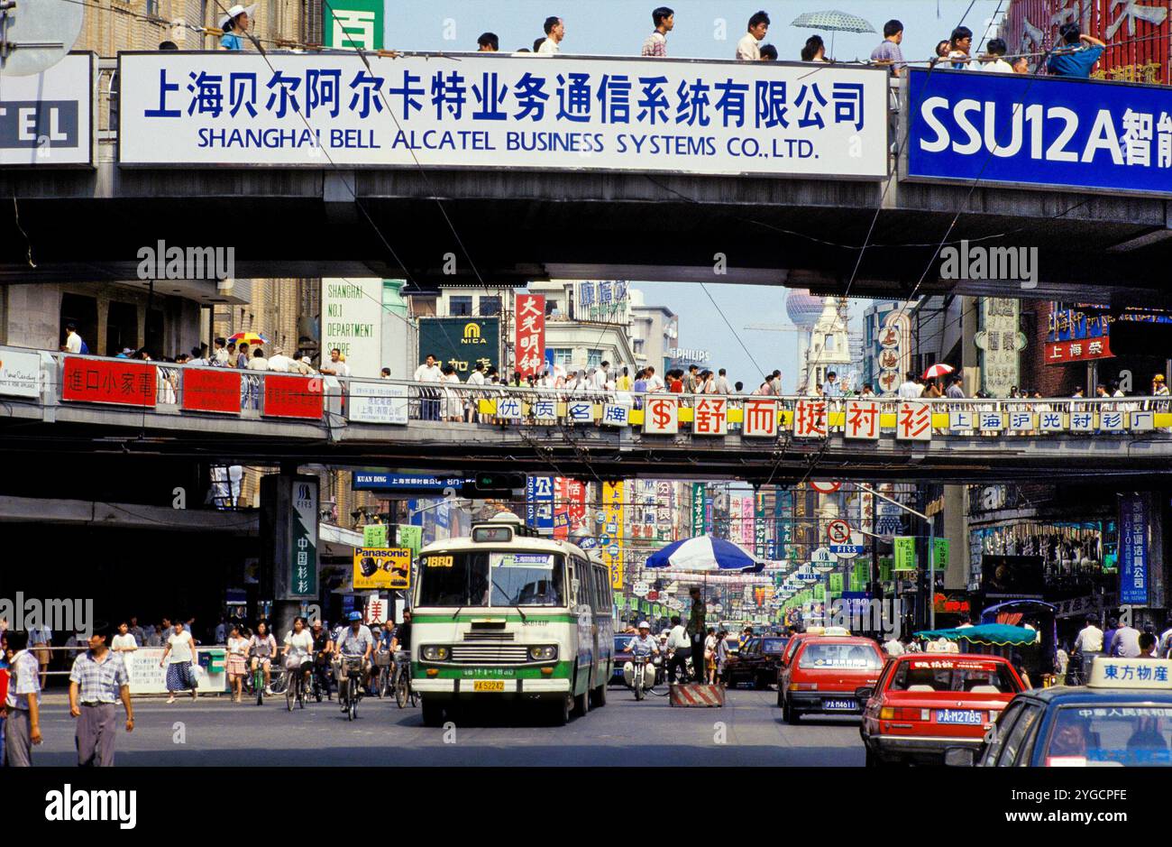 China, Shanghai, busy shopping street with pedestrian fly overs ...
