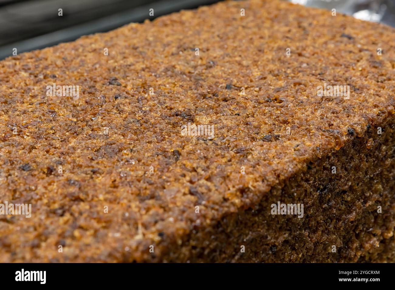 The close up image of the jagged brown natural raw rubber bales surface ...