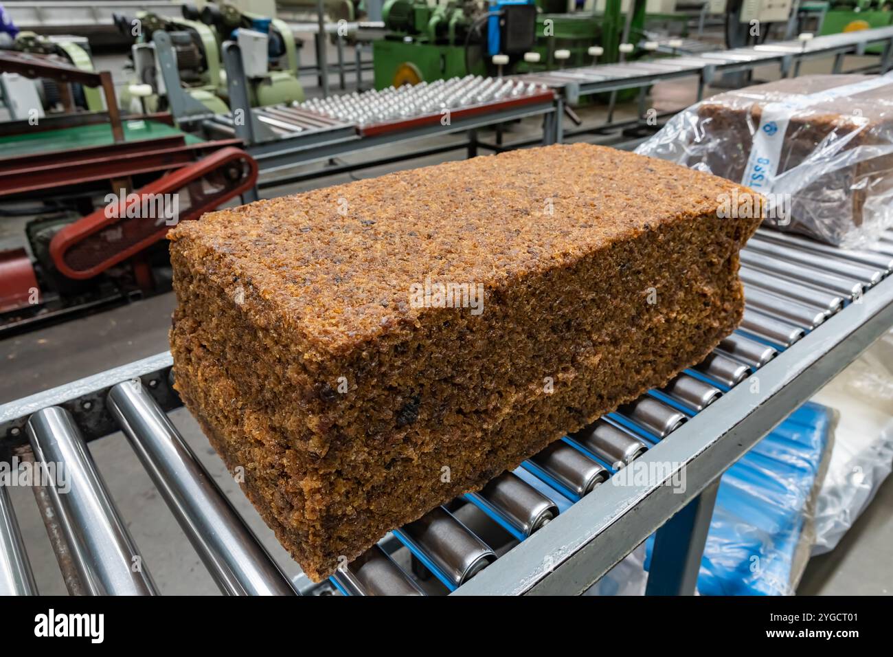 The natural rubber bales products on the industrial automatic conveyor ...