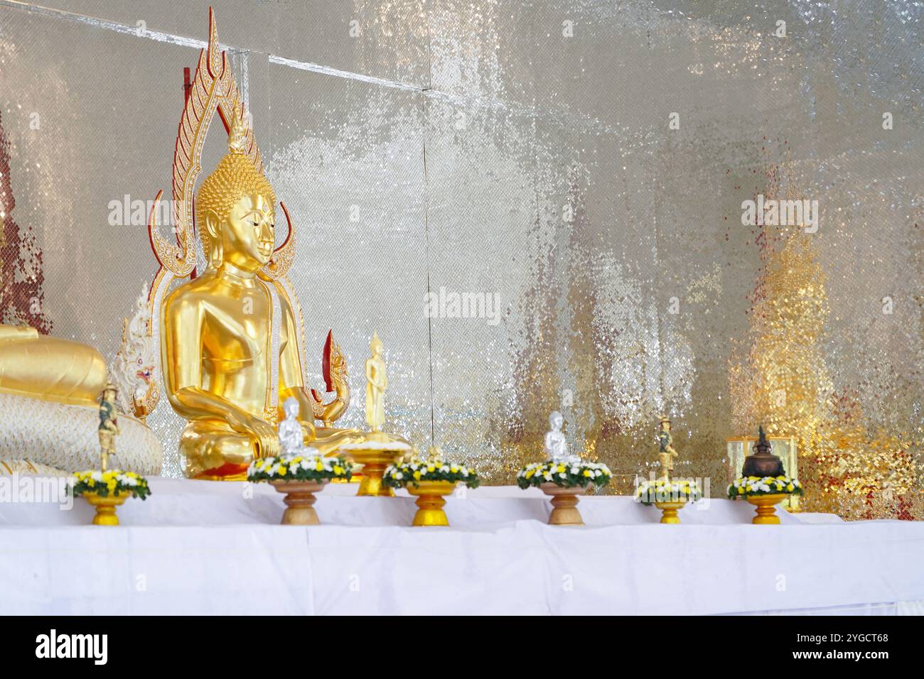 A stunning golden Buddha sculpture, exemplifying the deep reverence and ...