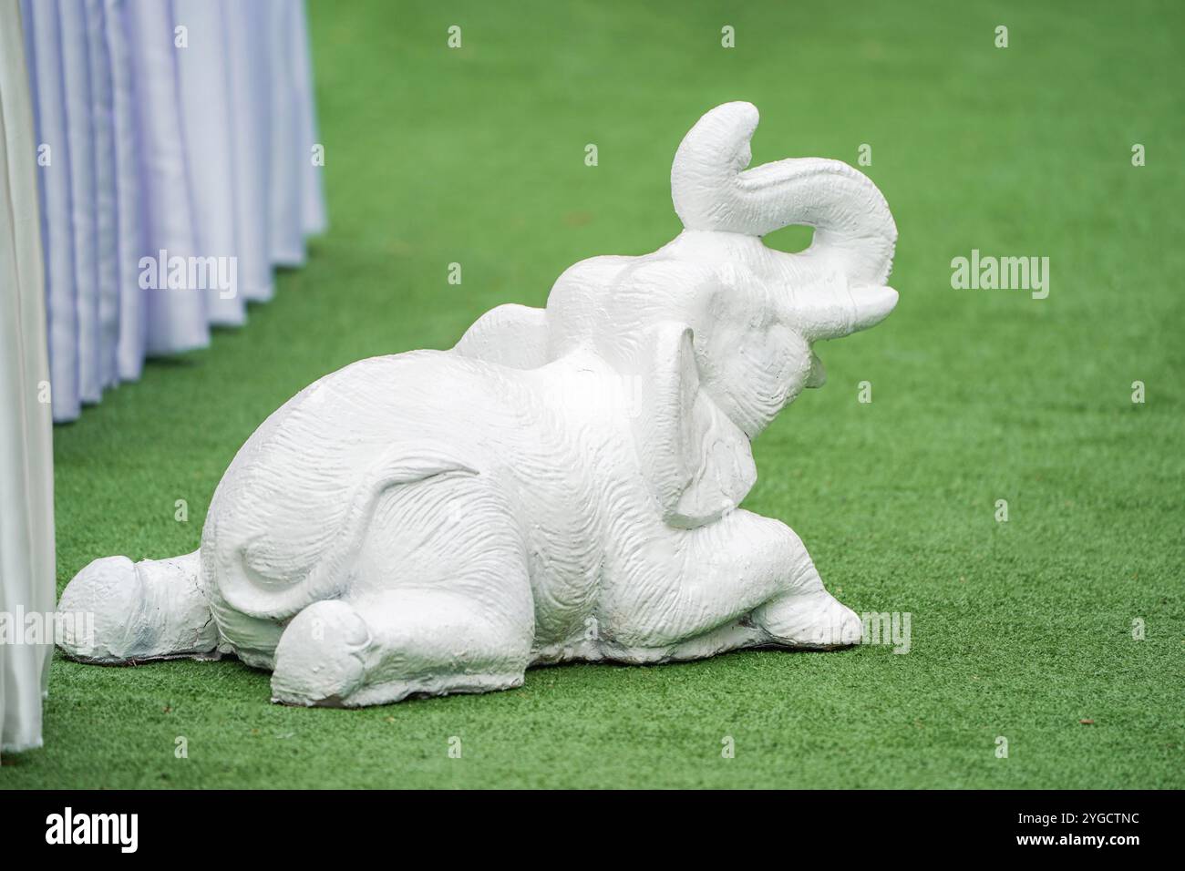 Asian Elephant statue figure sit and lay on the green turf Stock Photo ...
