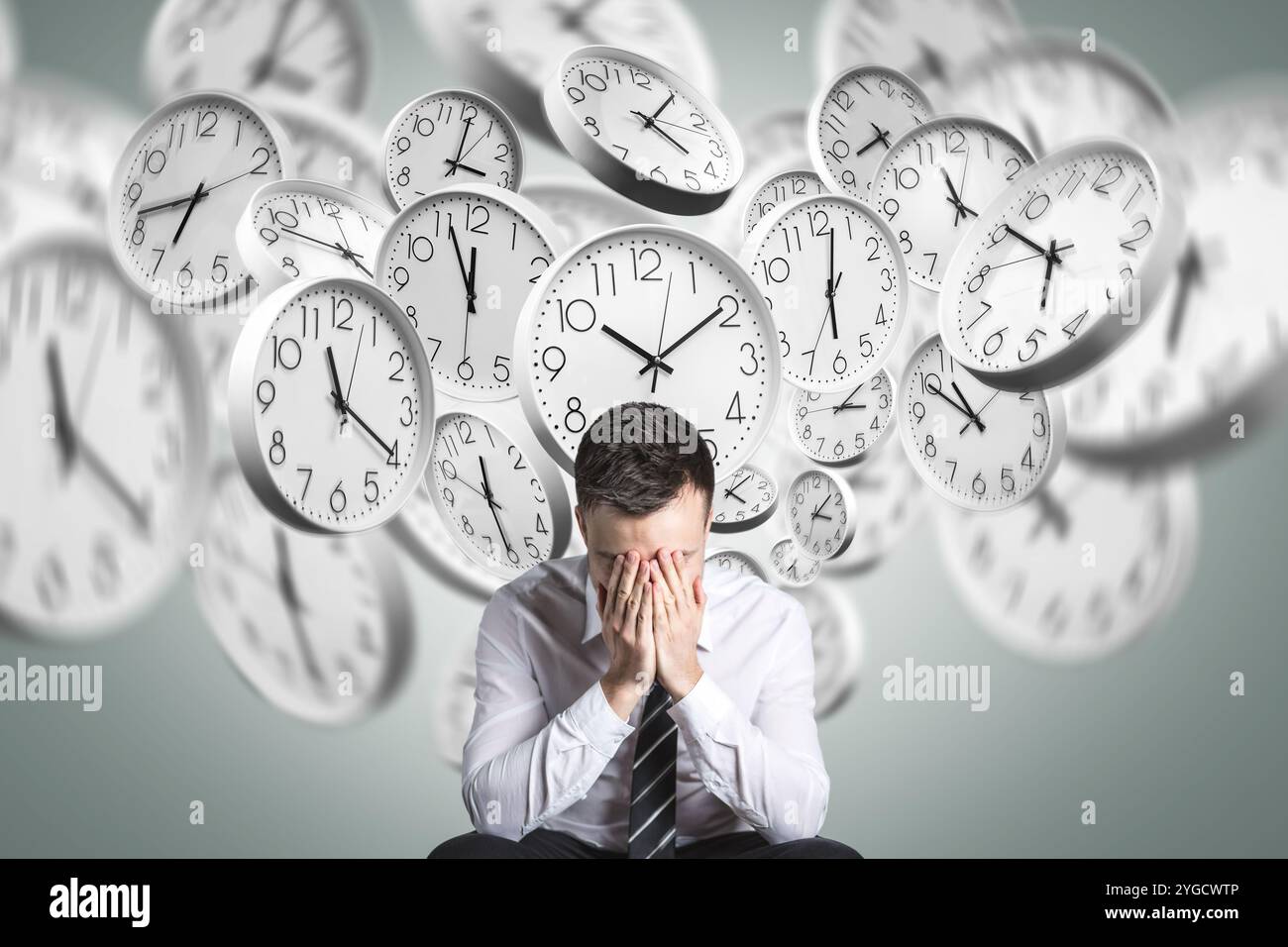 Stressed person overwhelmed by time pressure with clocks in background ...