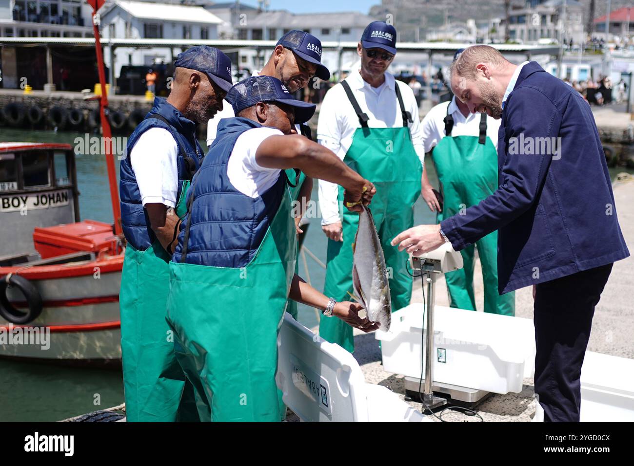 The Prince of Wales is shown a yellowfin tuna fish, while meeting local ...