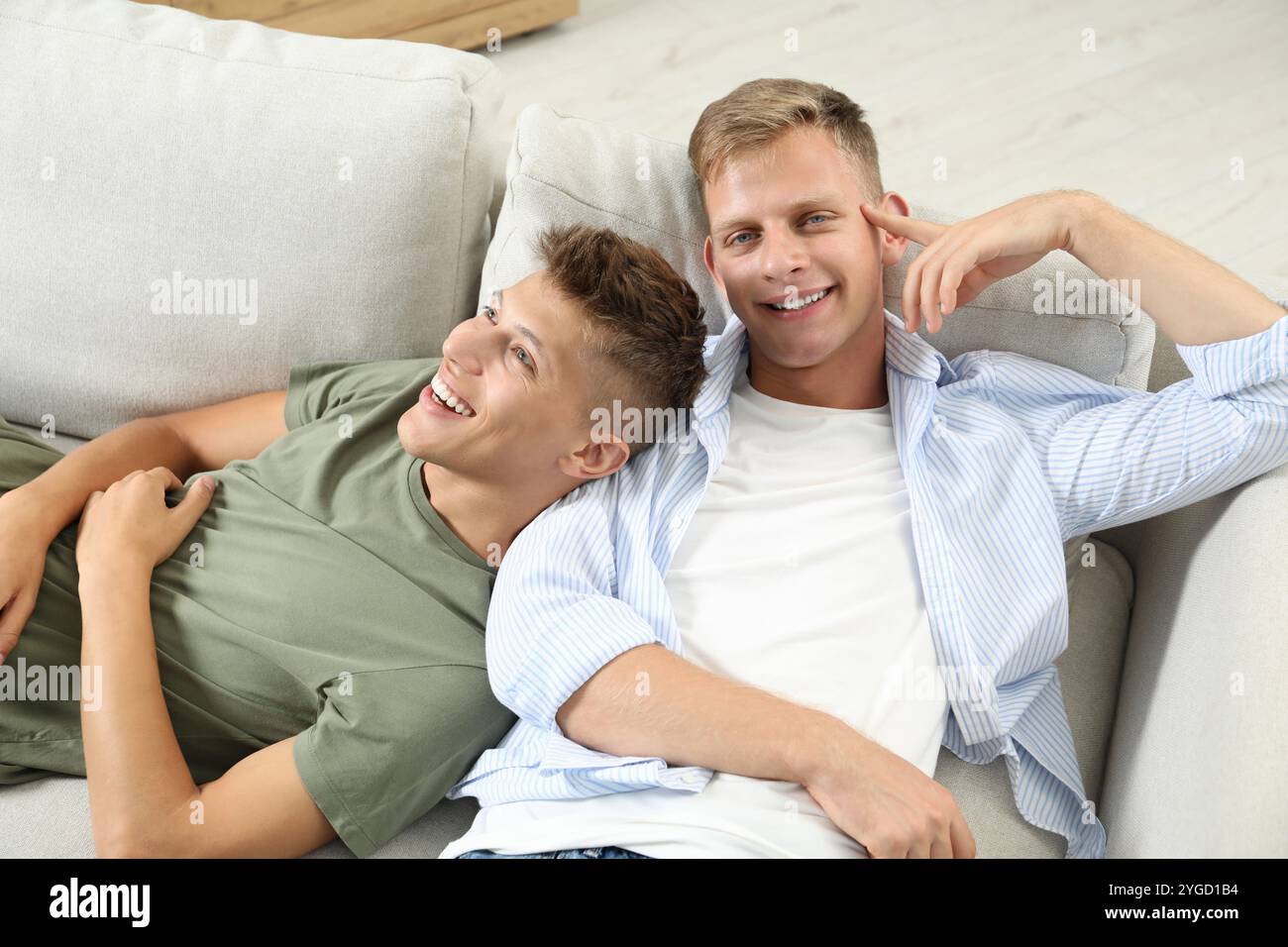 Happy brothers chilling on sofa at home Stock Photo - Alamy