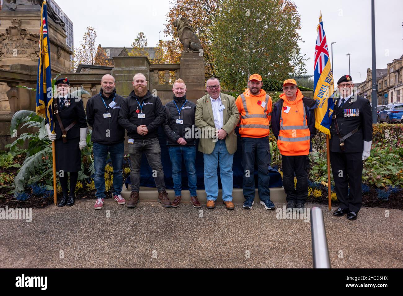 Wrokers who constructed the memorial plinth alongside standard bearers ...