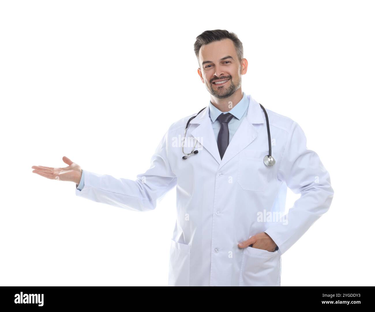 Smiling doctor with stethoscope pointing at something on white ...