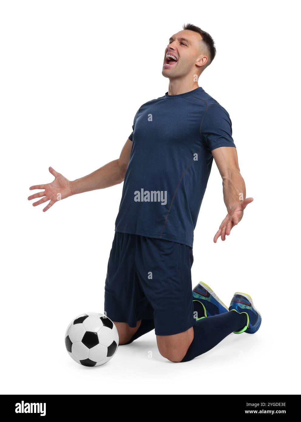 Emotional football player shouting and soccer ball on white background ...