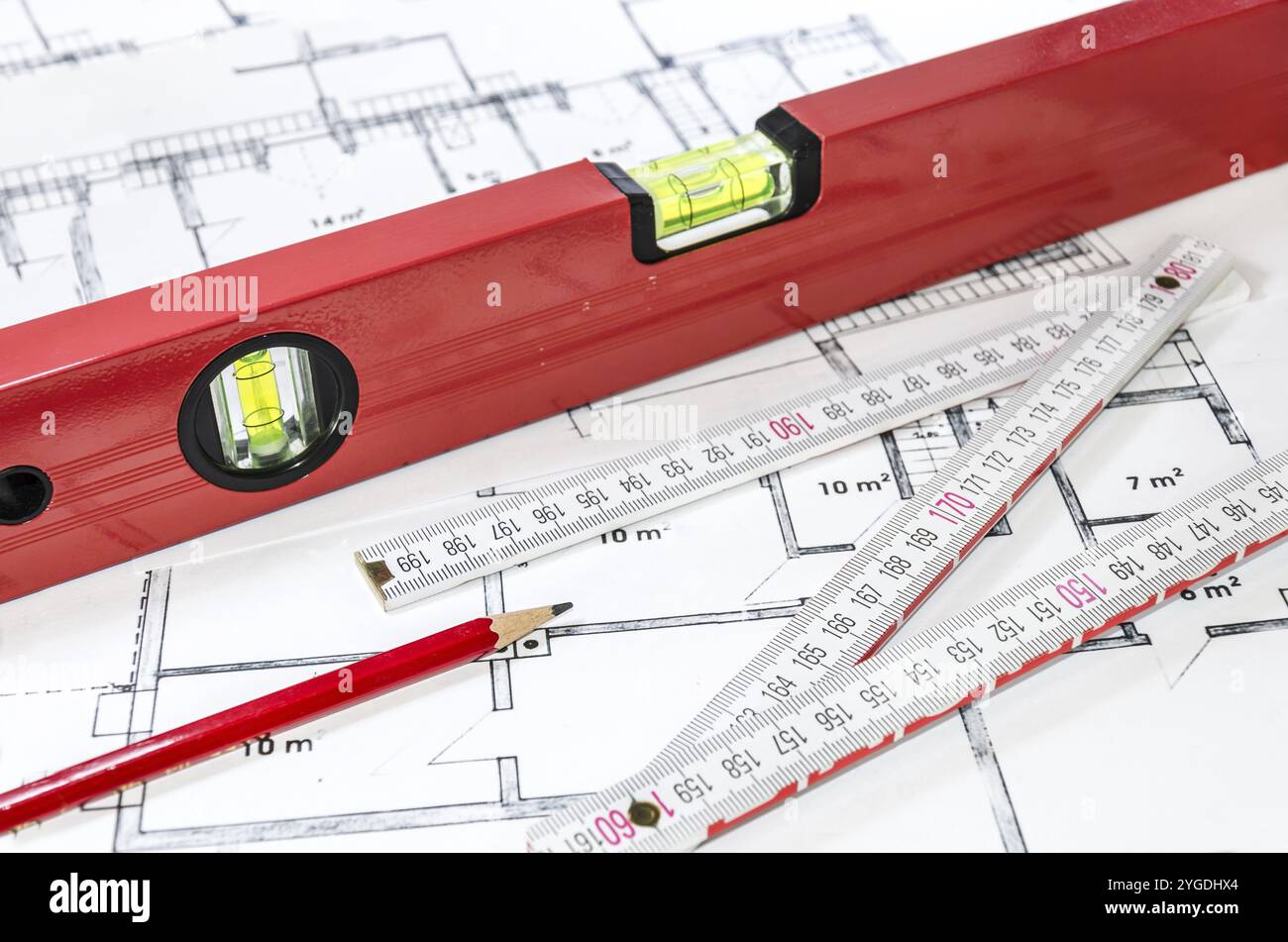 Spirit level, pencil and yardstick on a construction plan Stock Photo ...