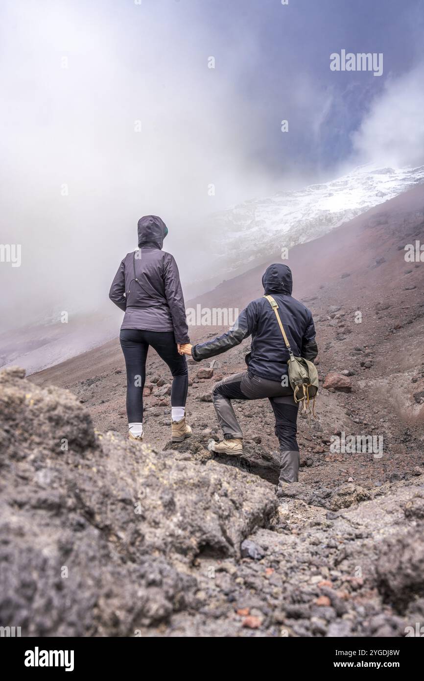 Couple standing in front of the Cotopaxi, Cotopaxi, Cotopaxi National ...