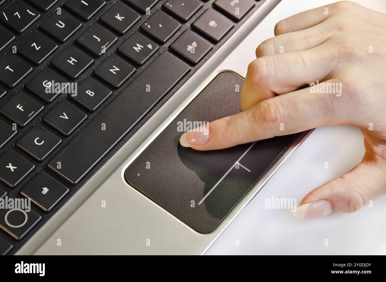 Female hand using track pad on a laptop Stock Photo - Alamy