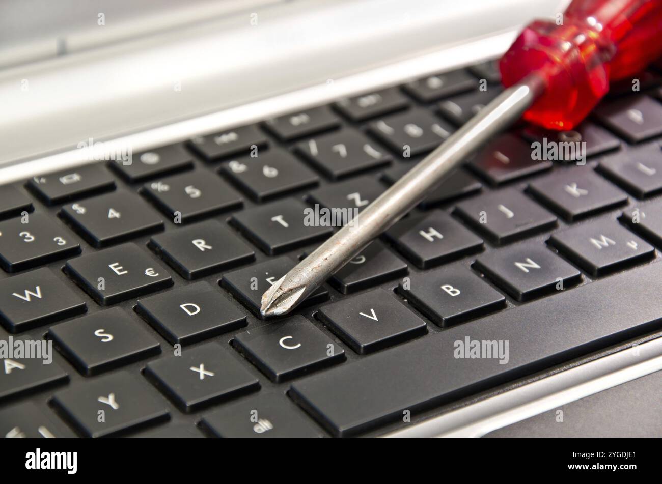 Screwdriver on computer keyboard symbolizing IT maintenance Stock Photo ...
