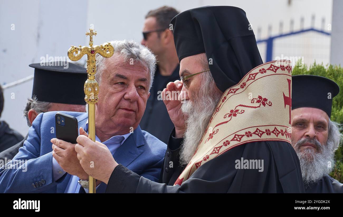 Archbishop Amphilochios, priest in religious dress looks at a ...