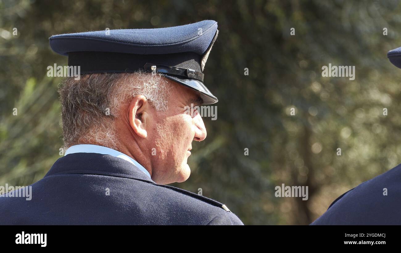 Back view of a Greek police officer in uniform, outdoors in daylight ...