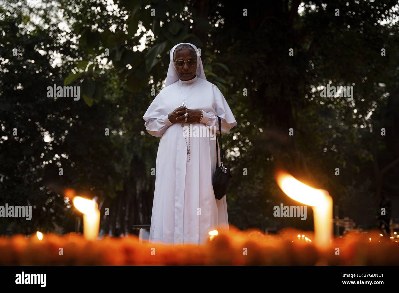 A Nun offer prayers on the grave during the All souls day observation ...