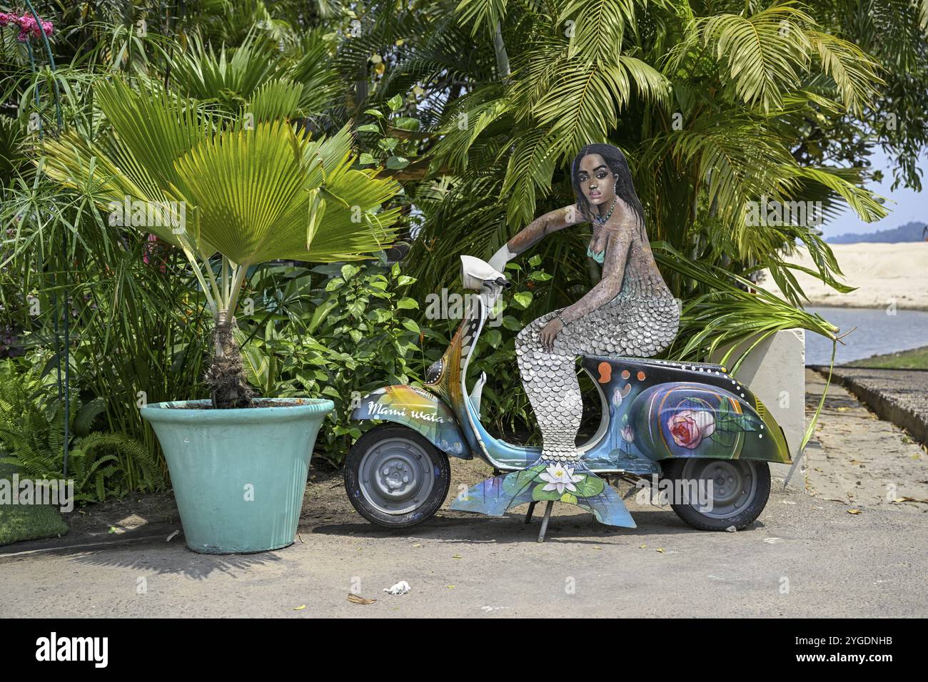 Figure of the water goddess Mami Wata on a Vespa in front of the Mami ...