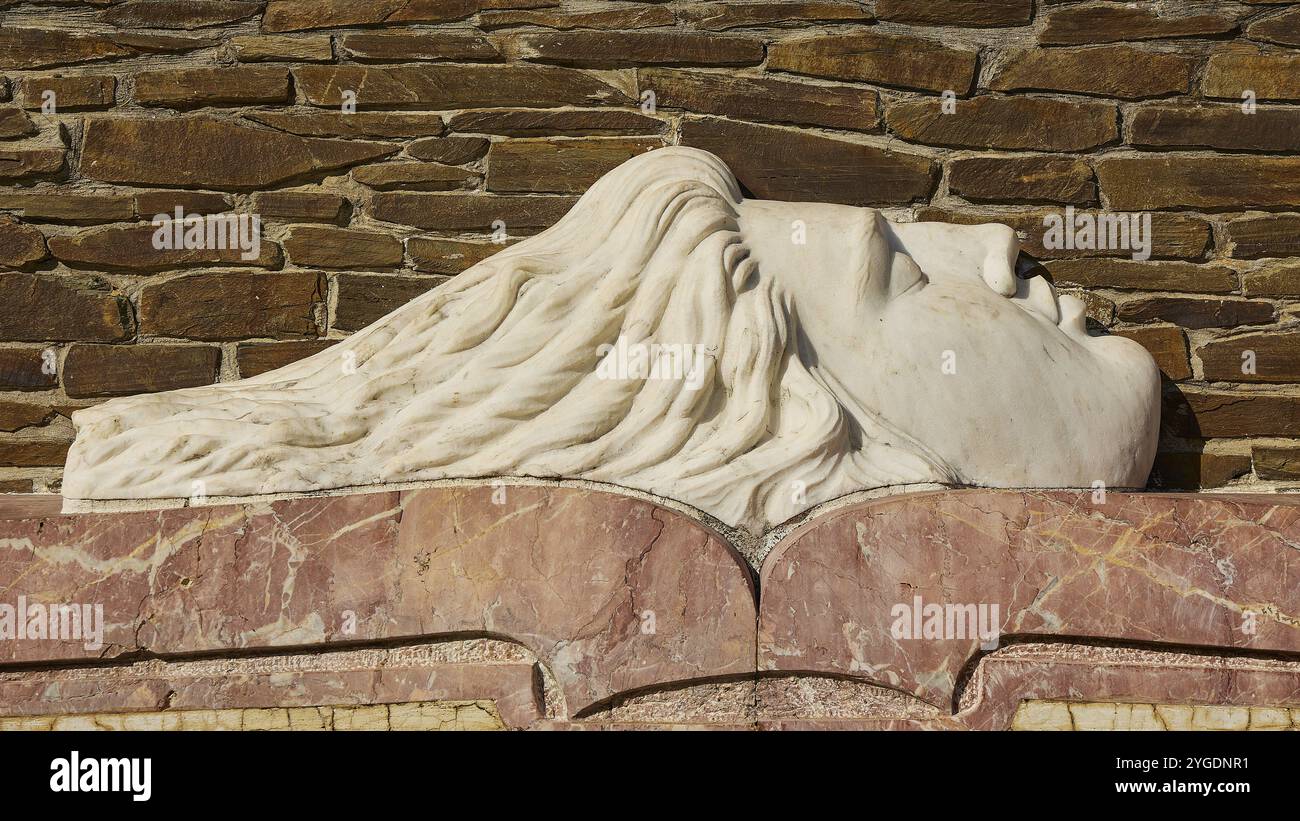 Relief of a reclining sculpture of a woman in stone carving on a stone ...