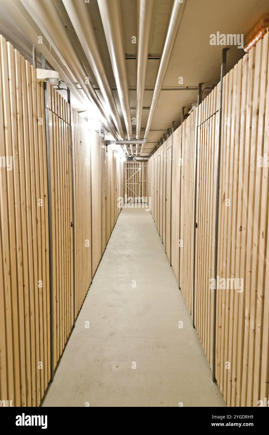 Aisle in a cellar with wooden storage units Stock Photo - Alamy
