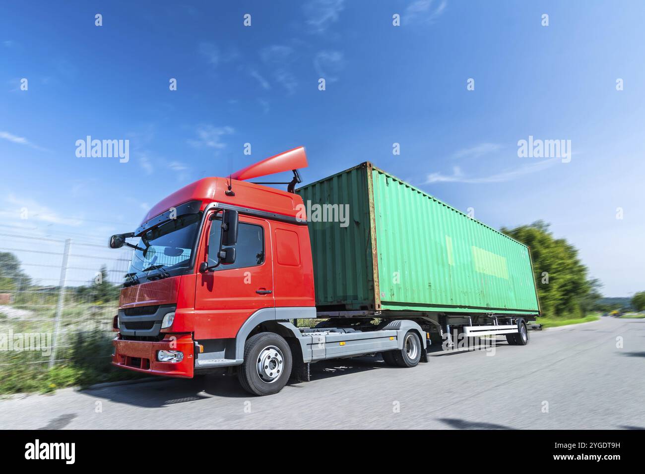 Truck with container on the trailer is driving on the road Stock Photo ...