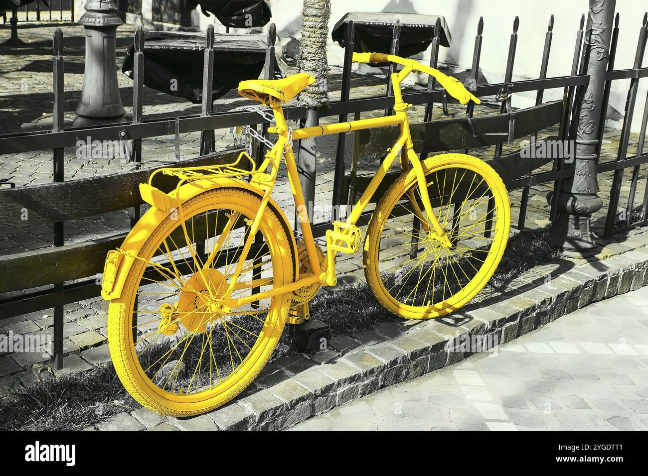 Colorful vibrant yellow color bicycle on the gray monochrome background ...