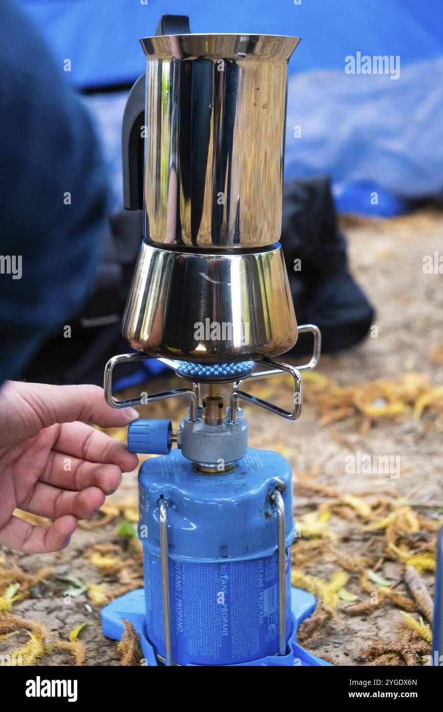 One person makes espresso on a camping cooker Stock Photo - Alamy