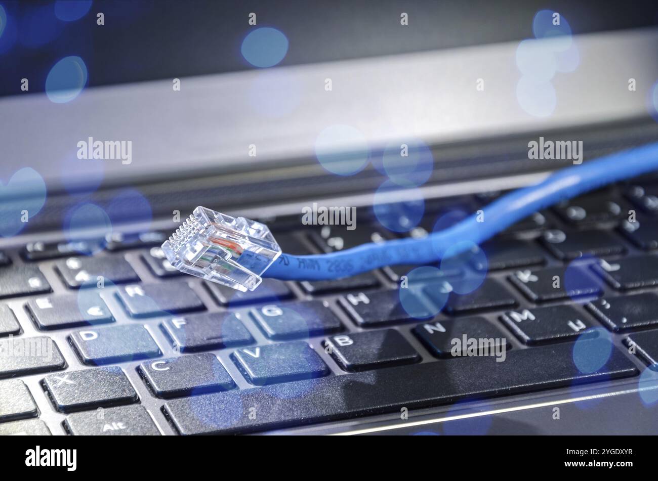 Internet LAN cable on a computer keyboard symbolizing cyberspace and ...