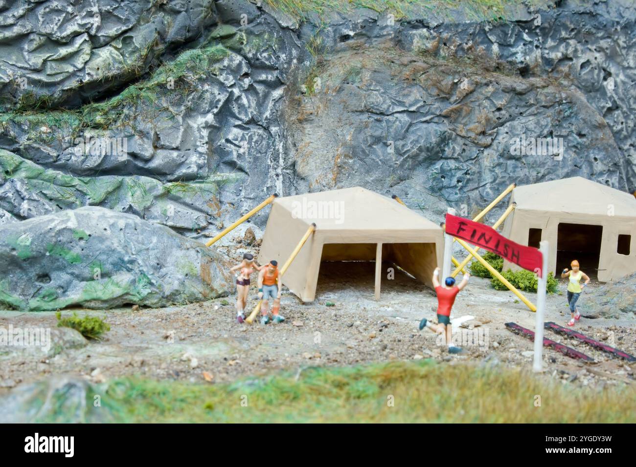 diorama of trail runners at the finish line of a race in rocky terrain ...