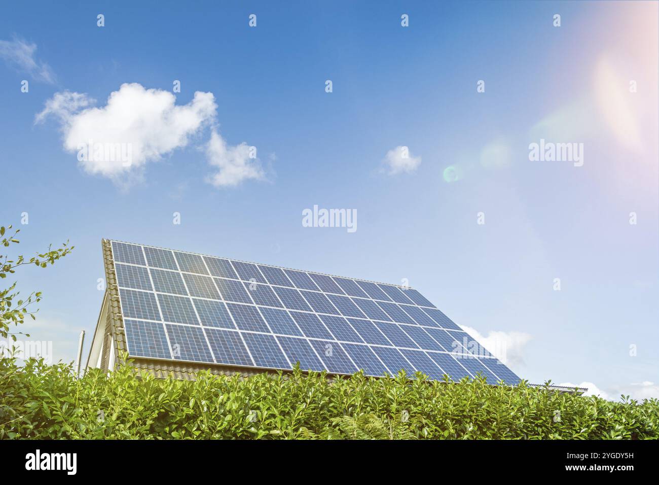 House with solar panels on the roof on a bright sunny day with scenic ...