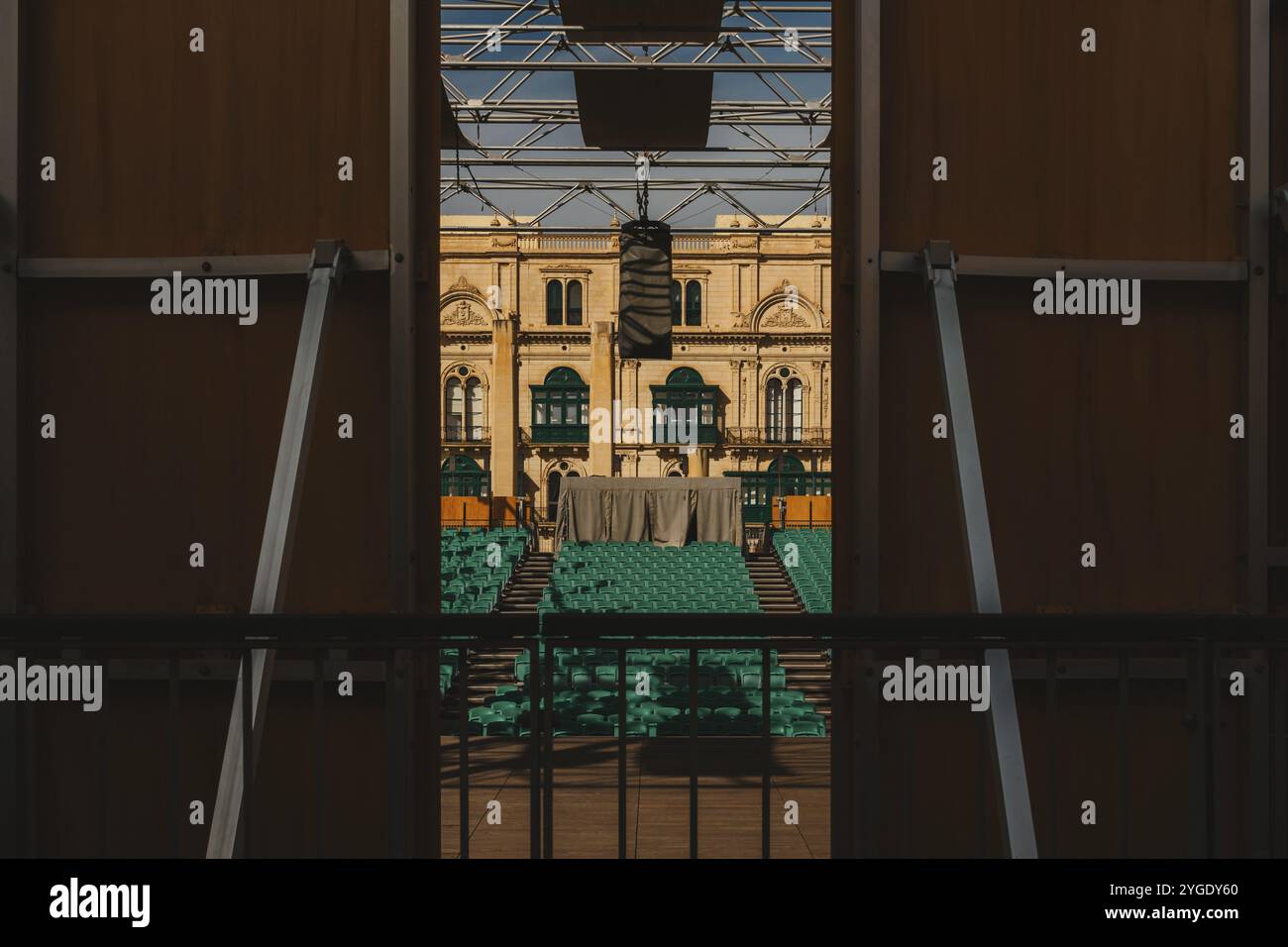 Behind the curtains, A view of the stage, stands and local architecture ...