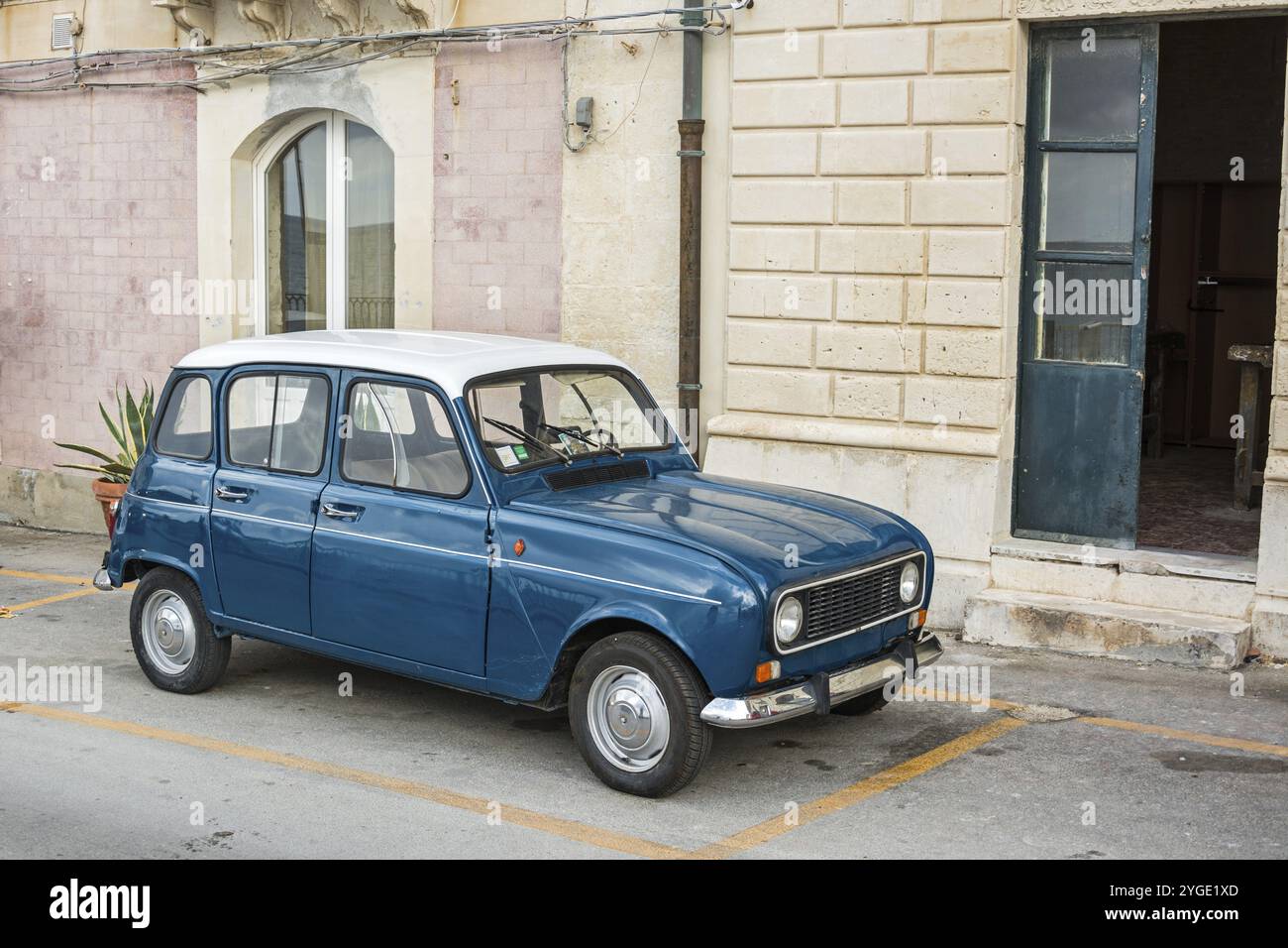 Beautiful vintage car in front of typical town houses in a ...