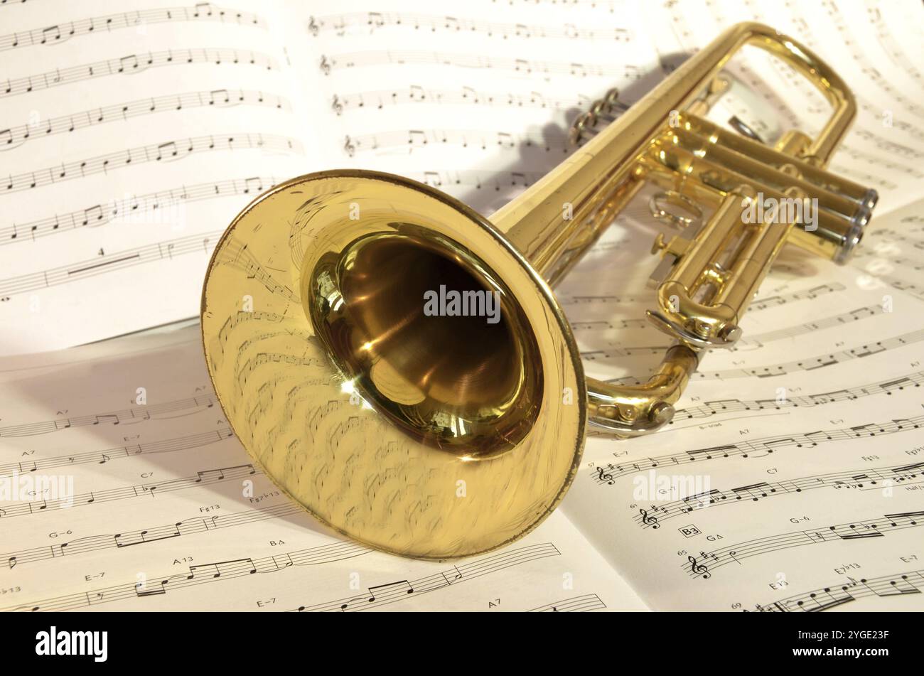 Trumpet lying on sheet music Stock Photo - Alamy