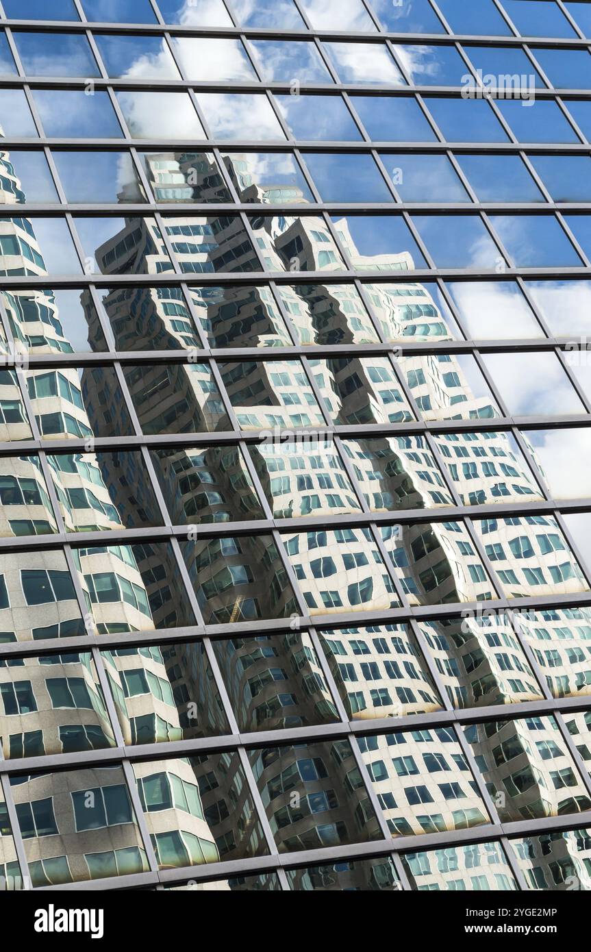 Reflection of high rise building in glass facade Stock Photo - Alamy