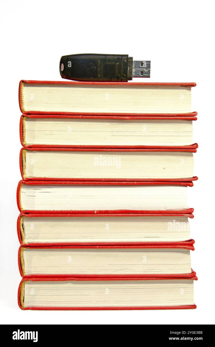 Pile of books with flash drive on top Stock Photo - Alamy