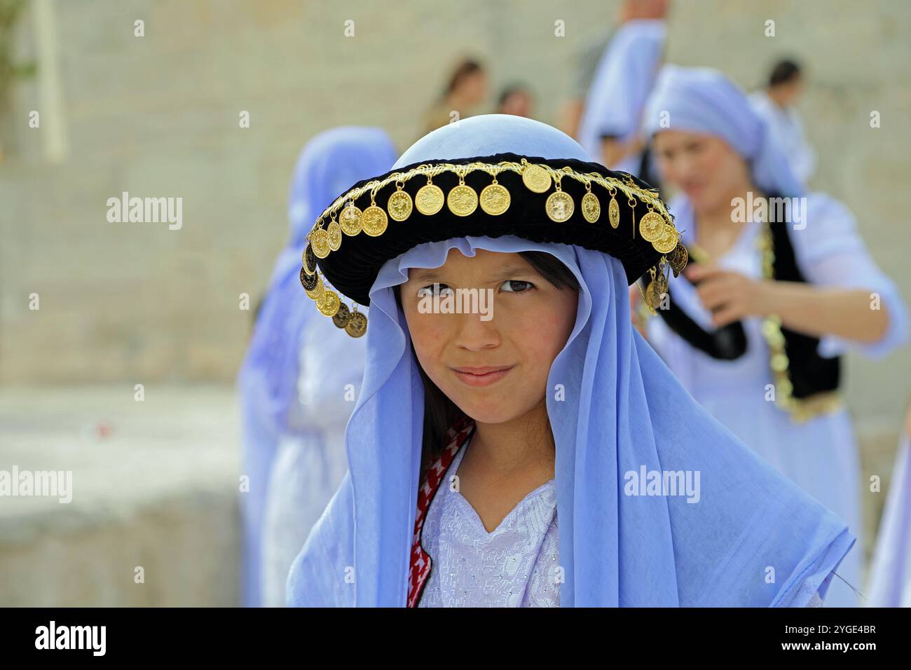 Yazidi girl in traditional dress at the holy site of Lalish in Iraqi ...