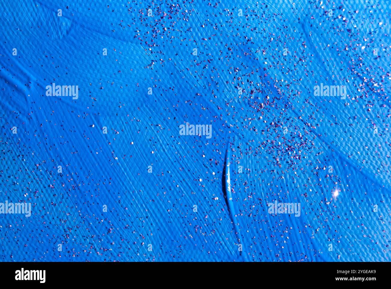Sparkly winter background with blue acrylic paint, creating a cool ...