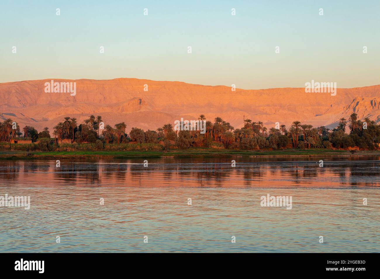 Landscape of mountains with palm trees on the Nile river banks, water ...